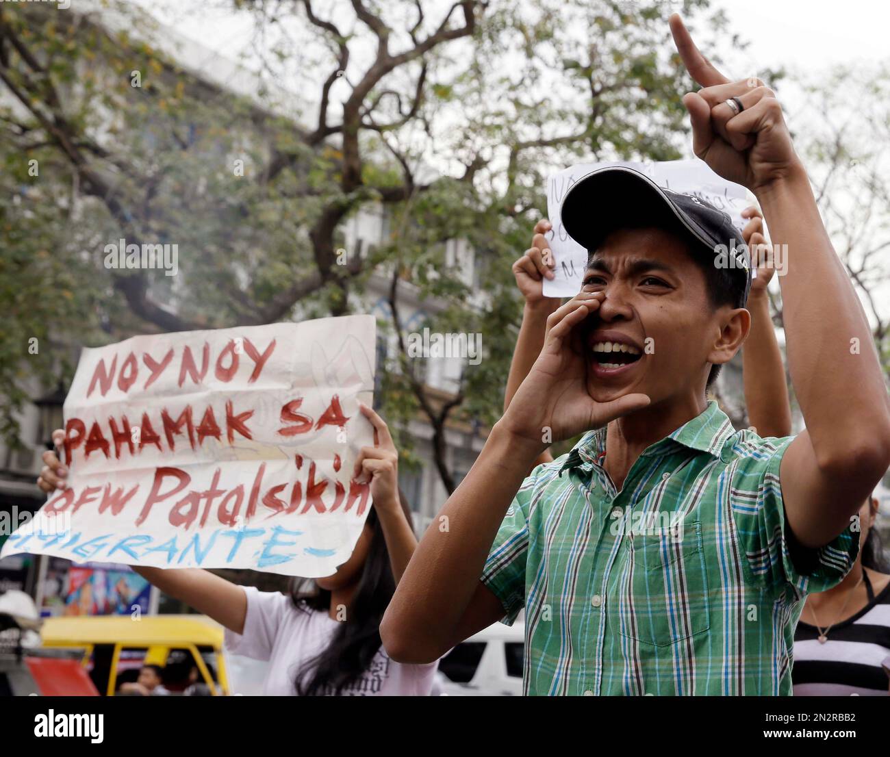 Protesters display placards and shout slogans calling for Philippine ...