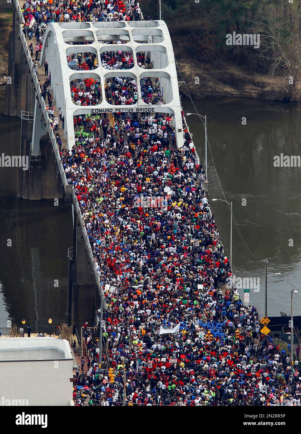 In this aerial view, Crowds of people move in a symbolic walk across ...