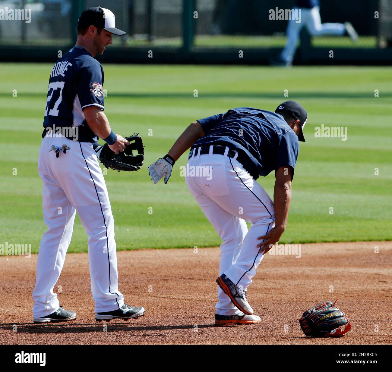 Detroit Tigers' Jose Iglesias, right, is helped by Andrew Romine after ...