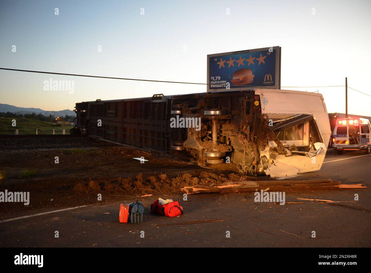 An overturned Metrolink passenger car rests on the side of the road after the train crashed into ...