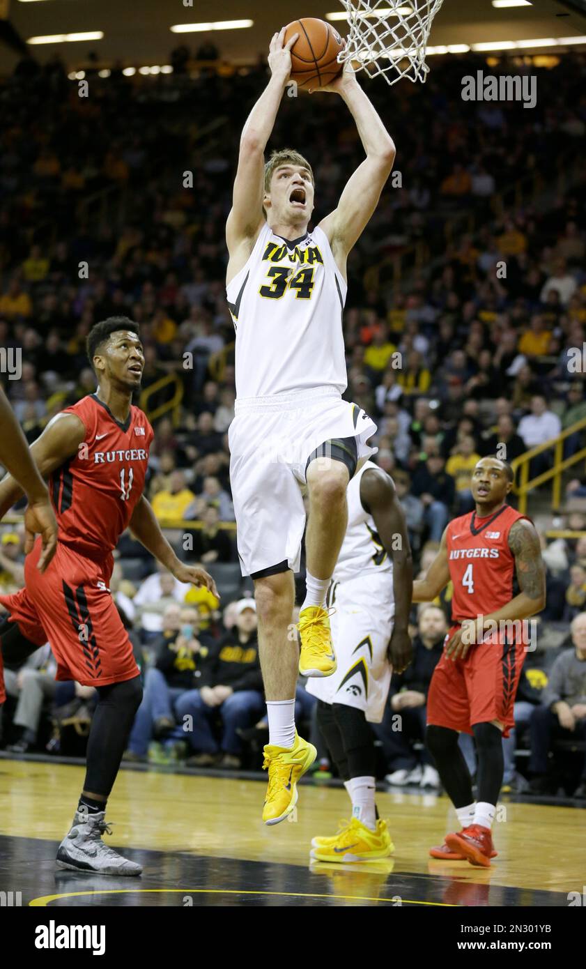 Iowa center Adam Woodbury, center, drives to the basket past Rutgers ...