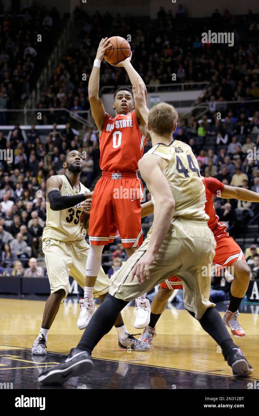 Ohio State guard D'Angelo Russell (0) shoots between Purdue guard Rapheal Davis (35)] and center ...