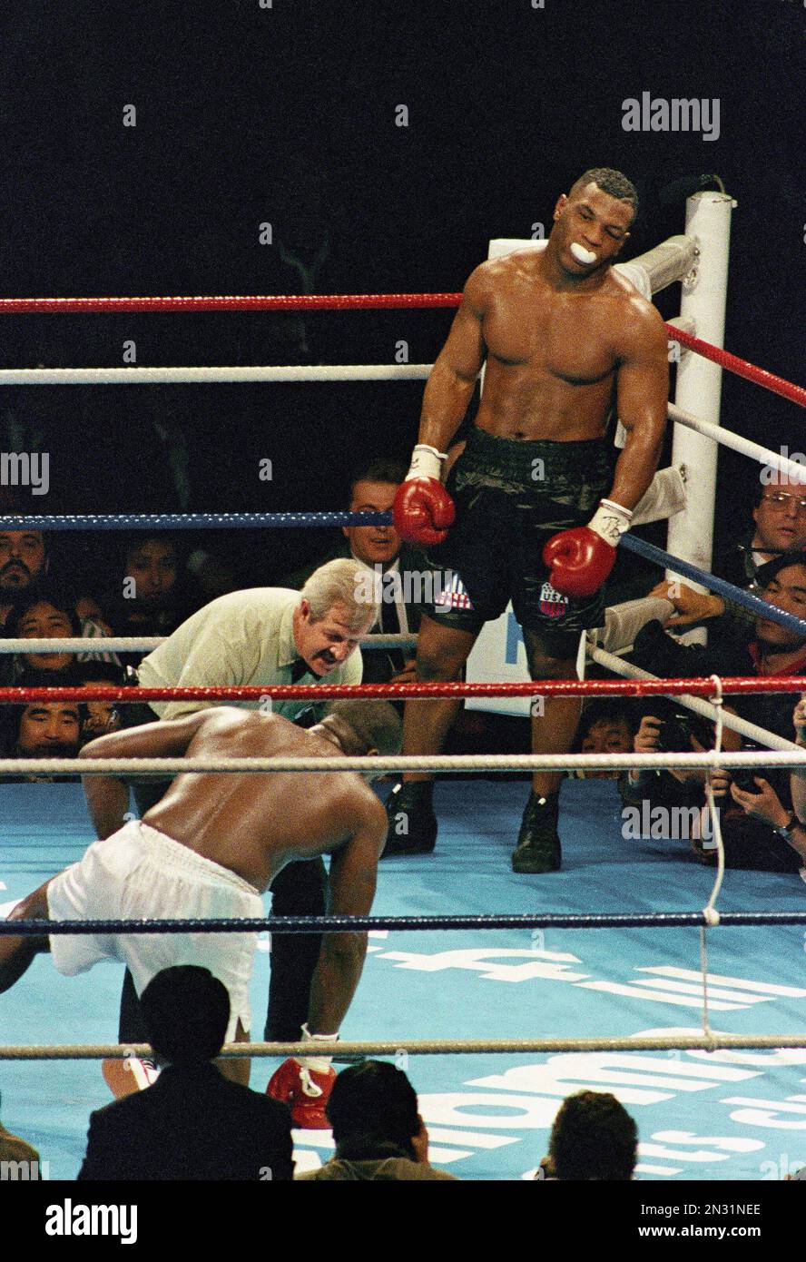 FILE - In this Feb. 11, 1990, file photo, champion Mike Tyson stands in ...