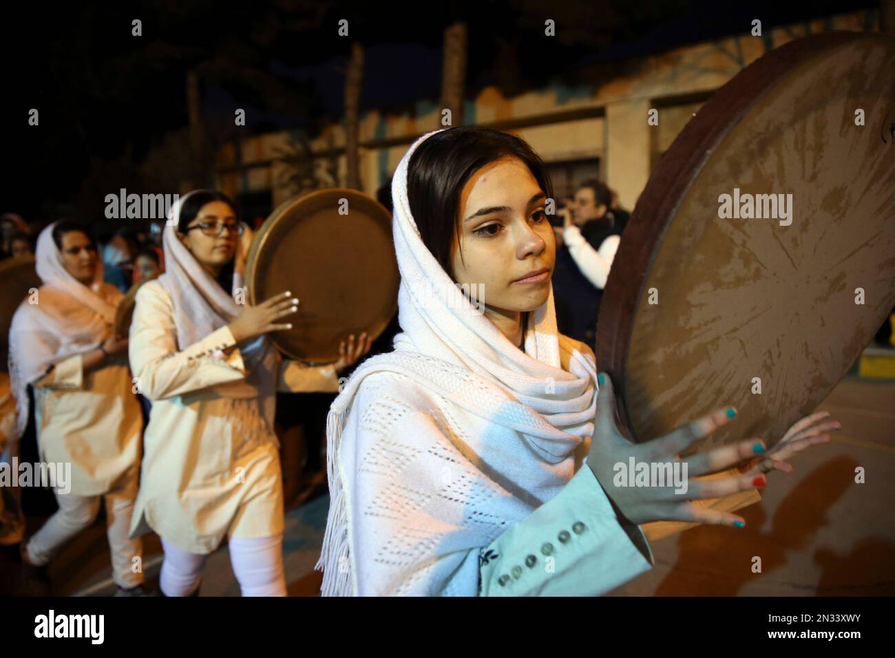Iranian Zoroastrian women play Daf, a large-sized tambourine, in a ...