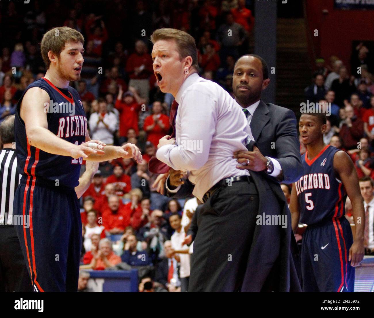 Richmond player T. J. Cline, left, and assistant coach Jamal Brunt ...
