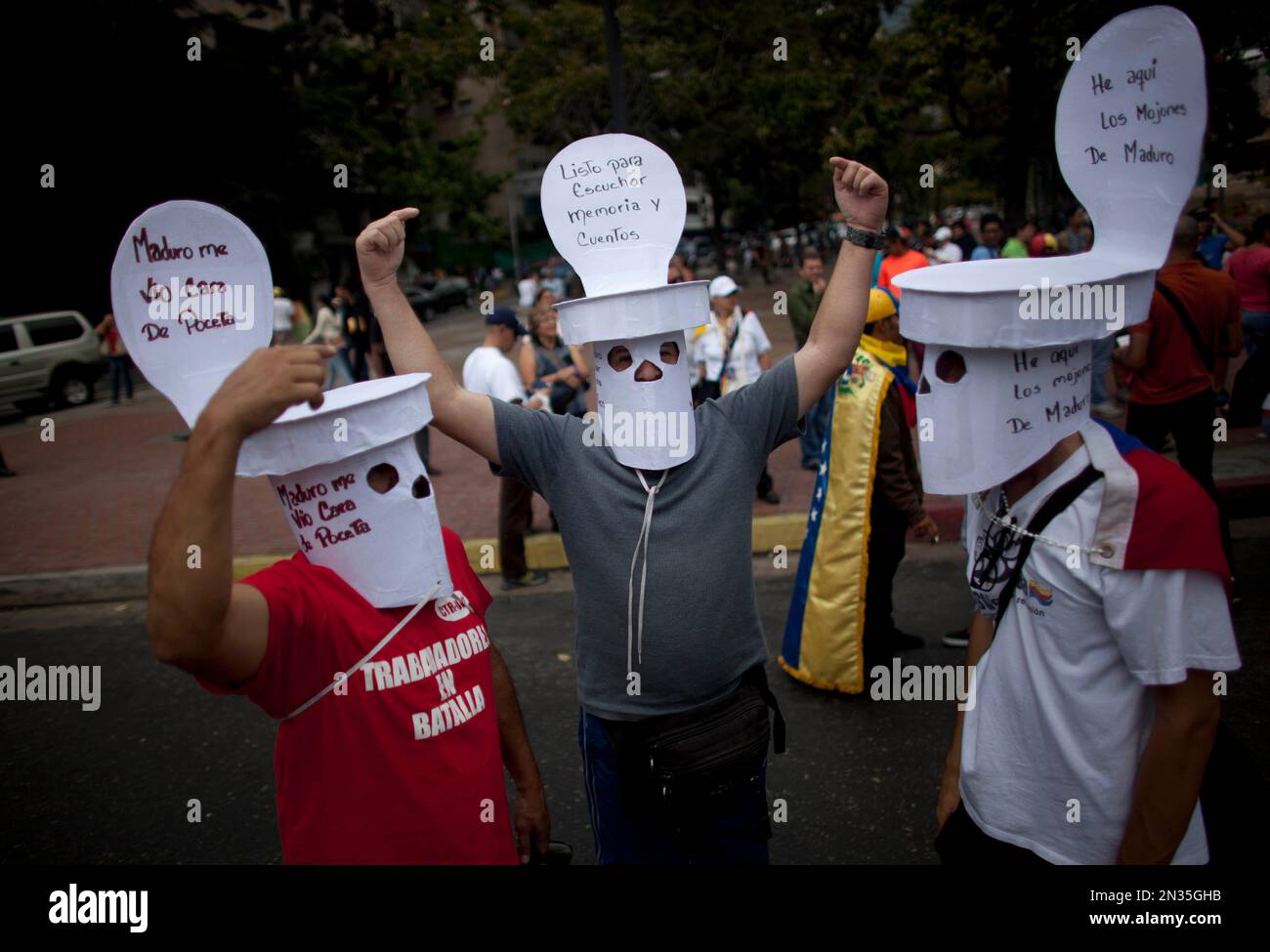 Opposition members with their faces covered with masks simulating a ...
