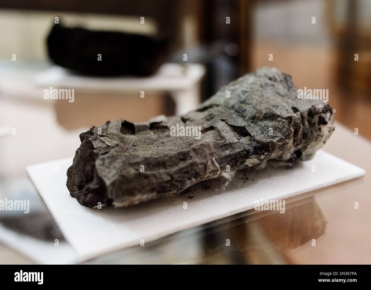 An ancient scroll, completely covered in blazing-hot volcanic material ...