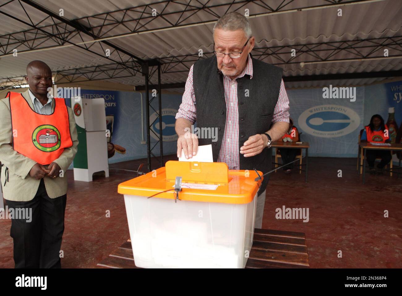 Zambian Acting President Guy Scott, right, casts his vote while an ...