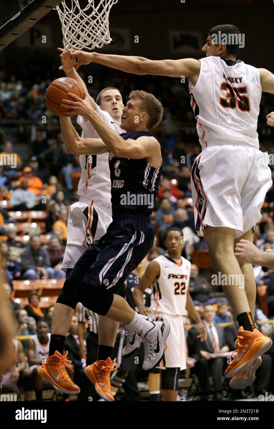 BYU guard Tyler Haws, center, drives to the basket between Pacific's ...