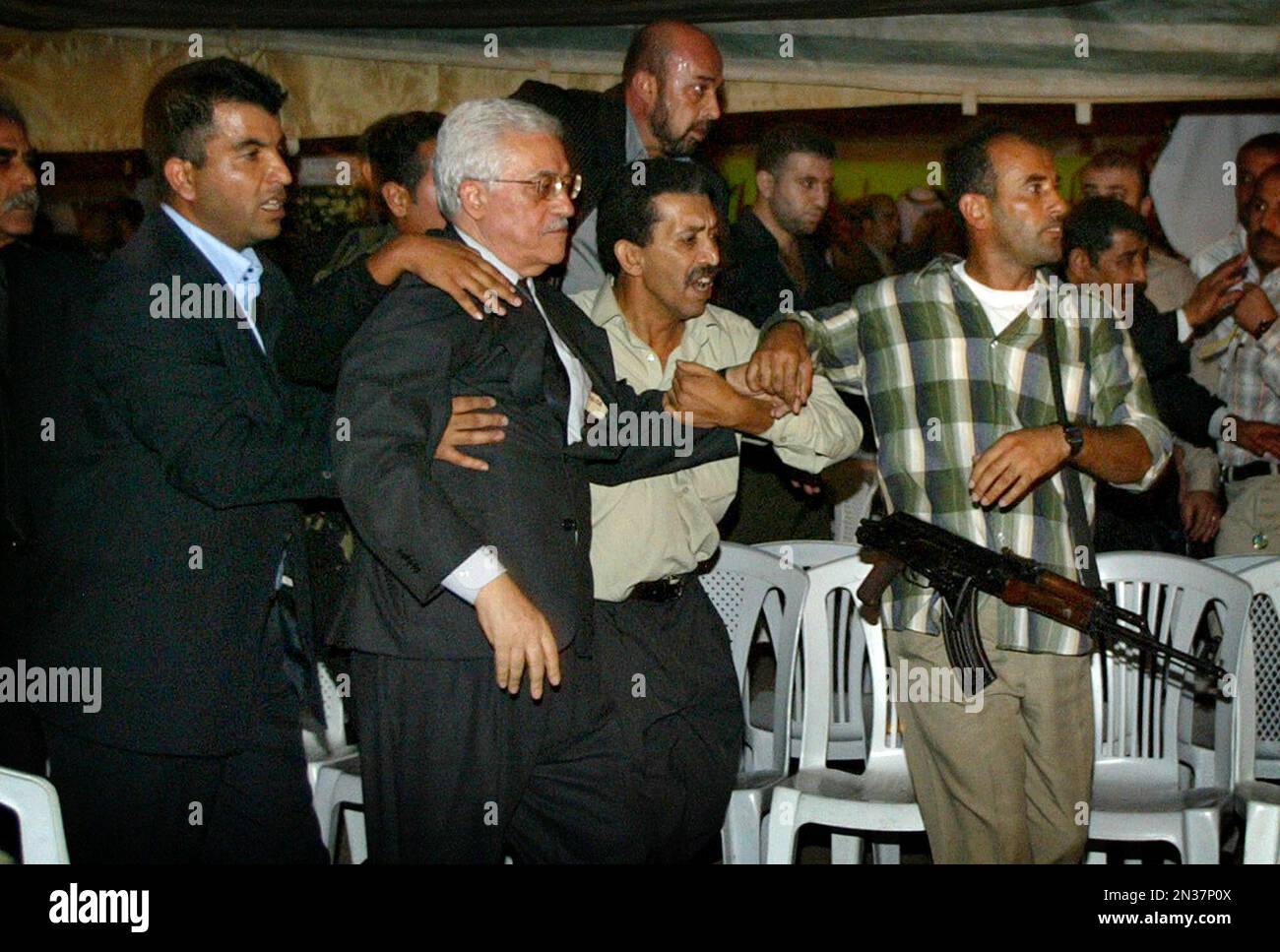 FILE - In this Nov. 14, 2004 file photo, bodyguards take away Mahmoud ...