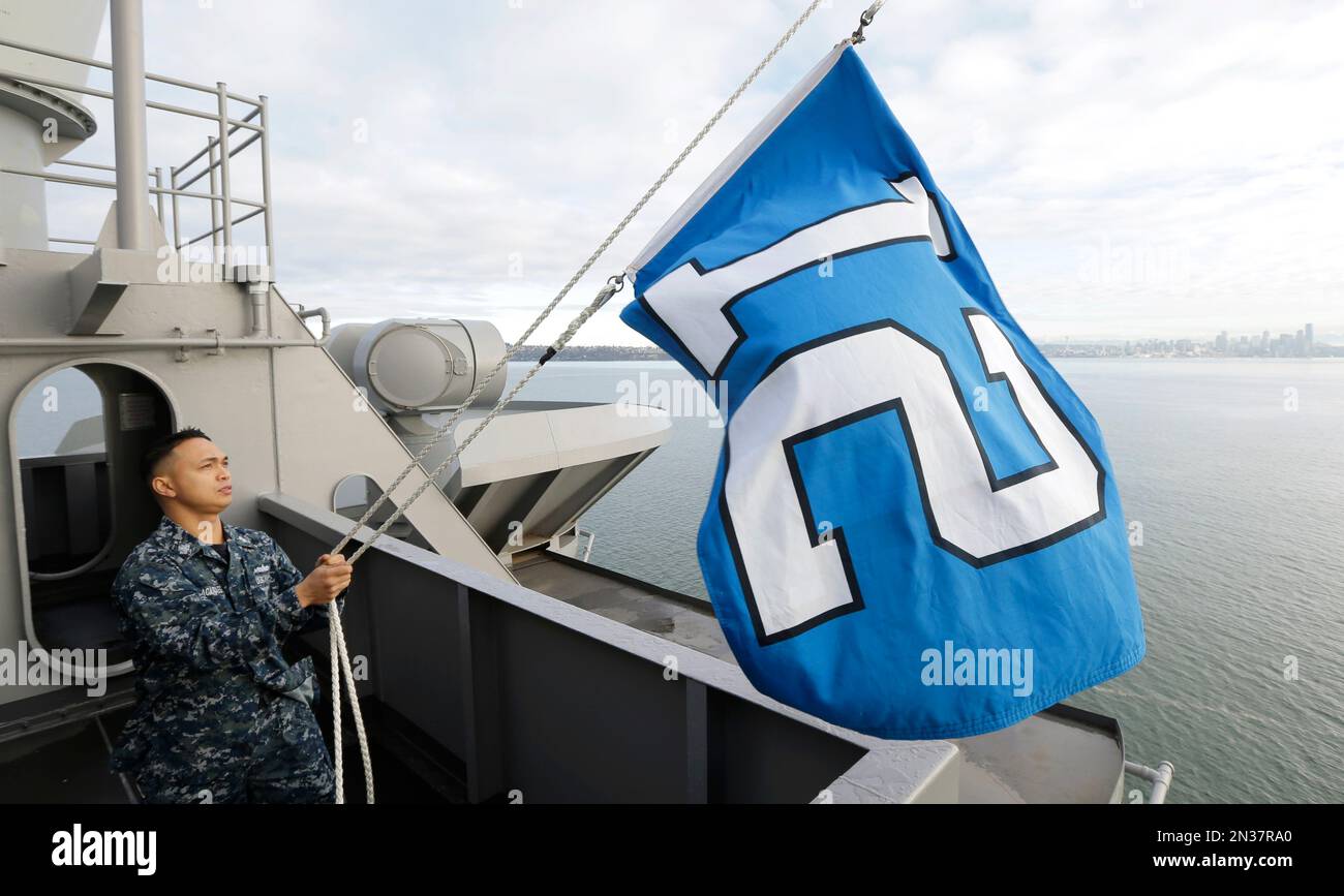 U.S. Navy Quartermaster 1st Class Dave Macaraeg demonstrates how the ...