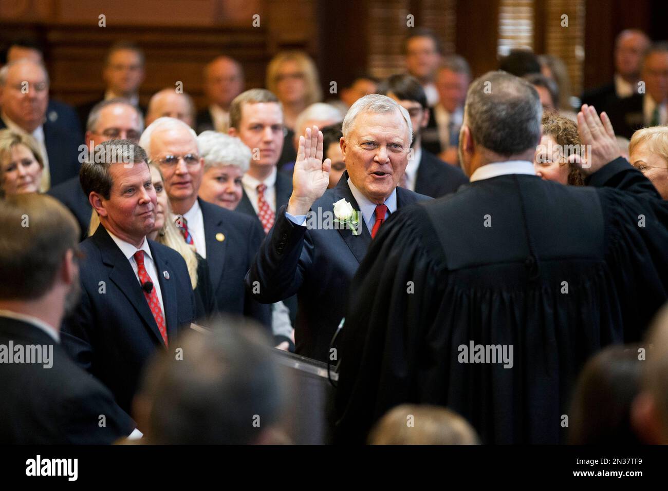 Georgia Gov. Nathan Deal, center, is sworn in by his son Judge Jason ...