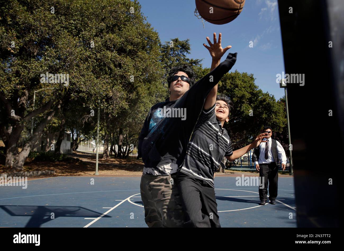 Saleh Khalaf, spends time playing basketball with his younger brother ...