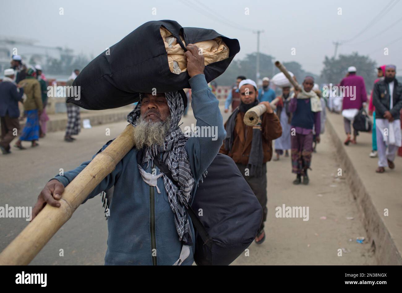 Bangladeshi Muslim devotees walk with their belongs to participate in ...