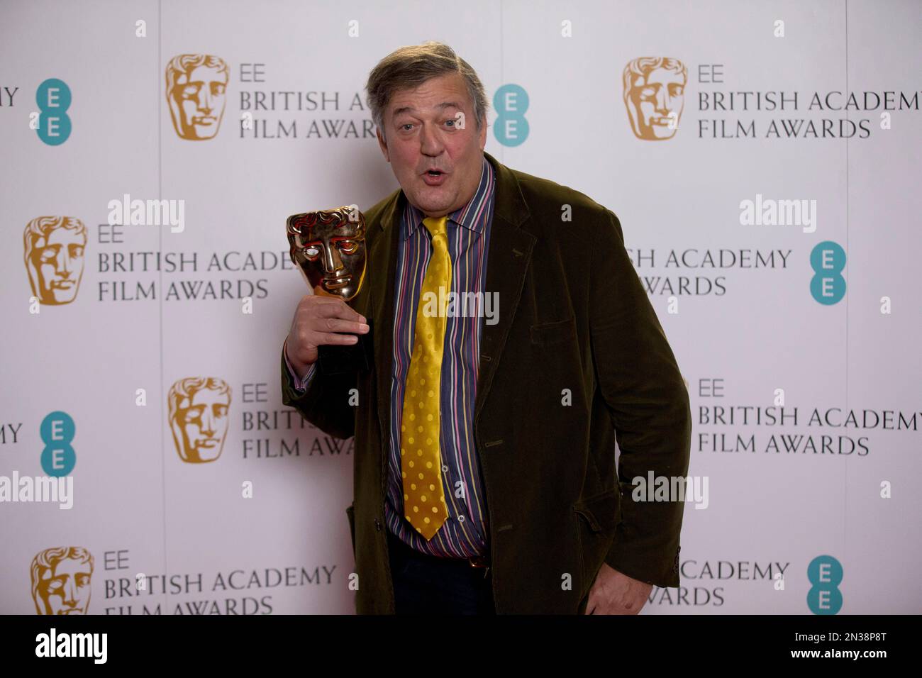 British comedian and actor Stephen Fry poses for photographs with a ...