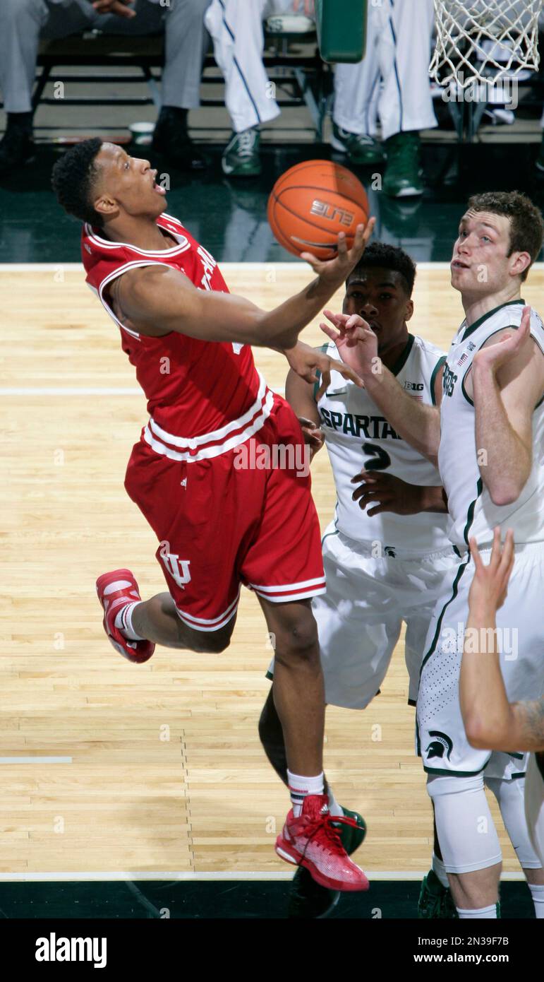 Indiana's Troy Williams, left, puts up a shot against Michigan State's ...