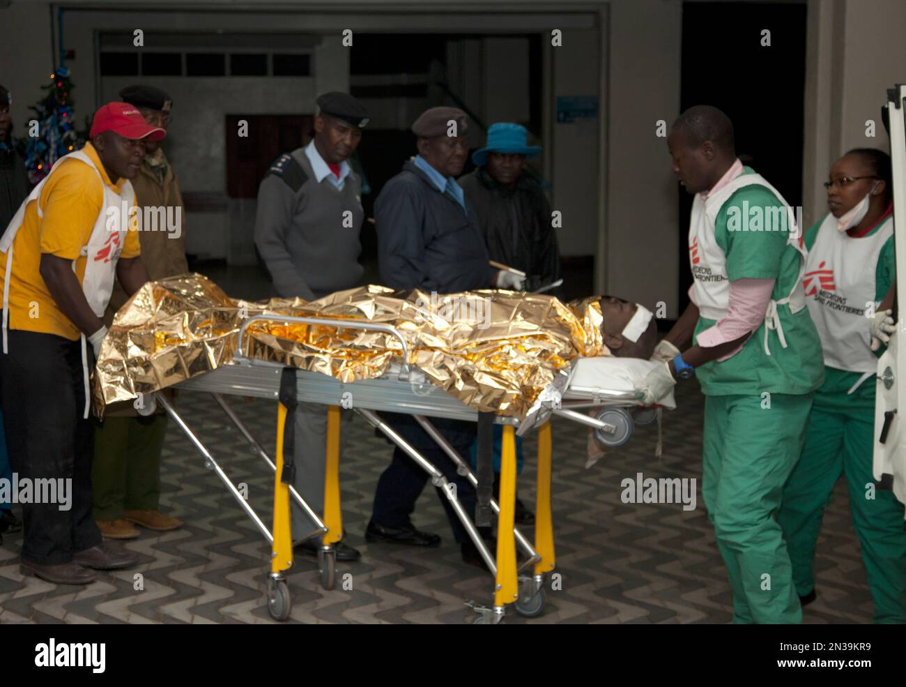 A survivor of a multi-storey building collapse arrives for treatment at ...