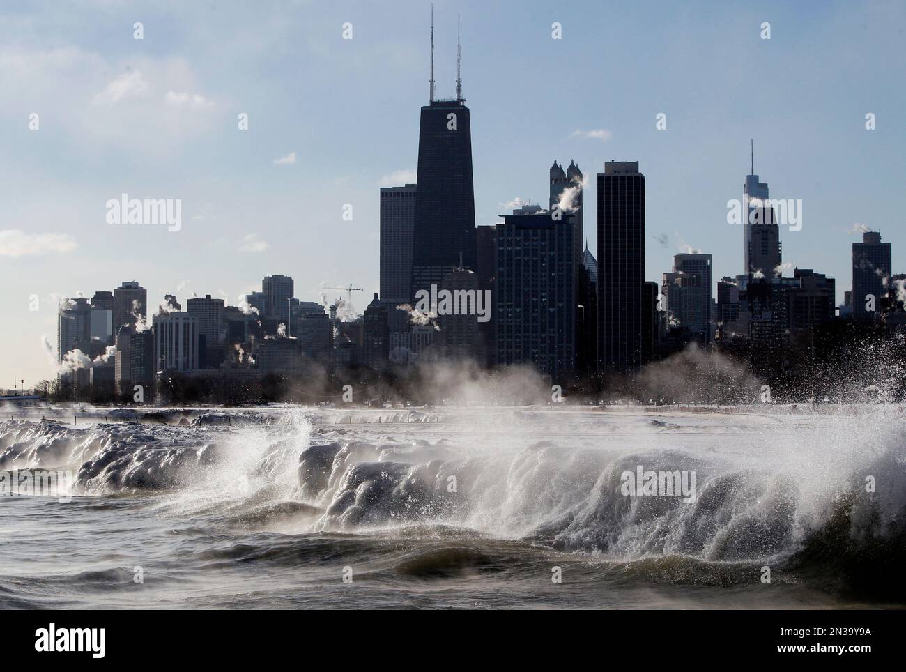FILE- In this Jan. 27, 2014, file photo, ice forms as waves crash along ...