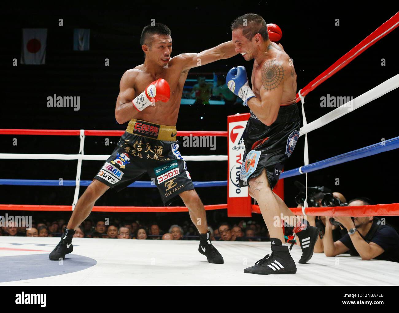 Japanese champion Takashi Uchiyama, left, sends a left to Argentine ...