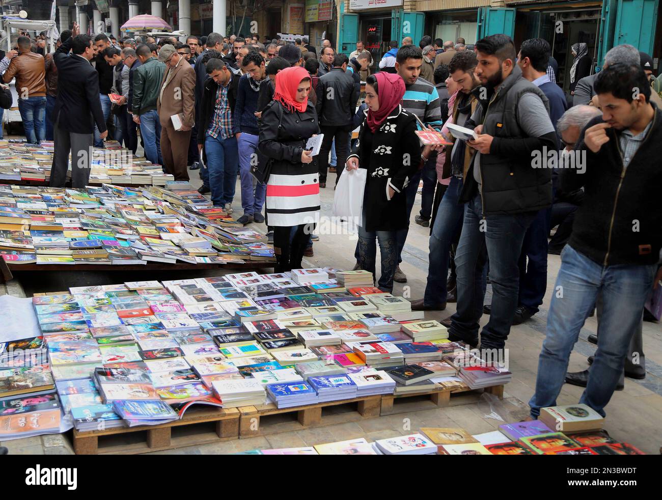 Iraqis look at books on al-Mutanabi Street, home to the city's book ...