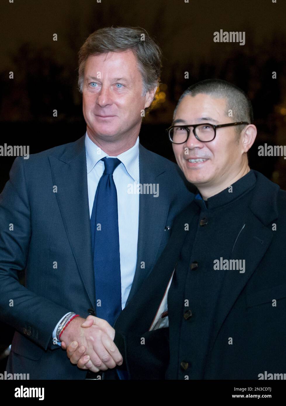 Sebastien Bazin, left, CEO of Accor hotel group, shakes hands with Ji ...