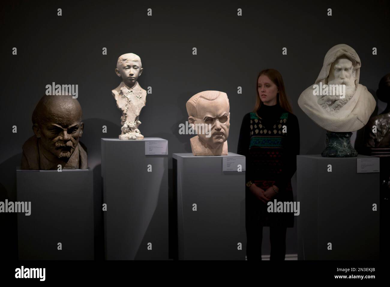 A Sotheby's auction house employee poses for photographs beside a ...