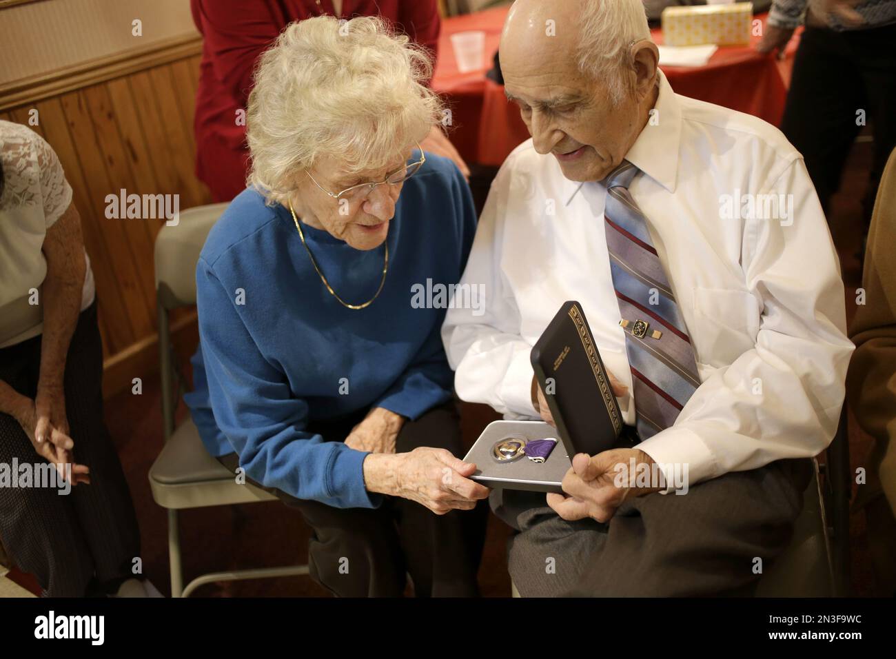 Leonard Stern, 88, right, shows his Purple Heart medal to friend Irma ...