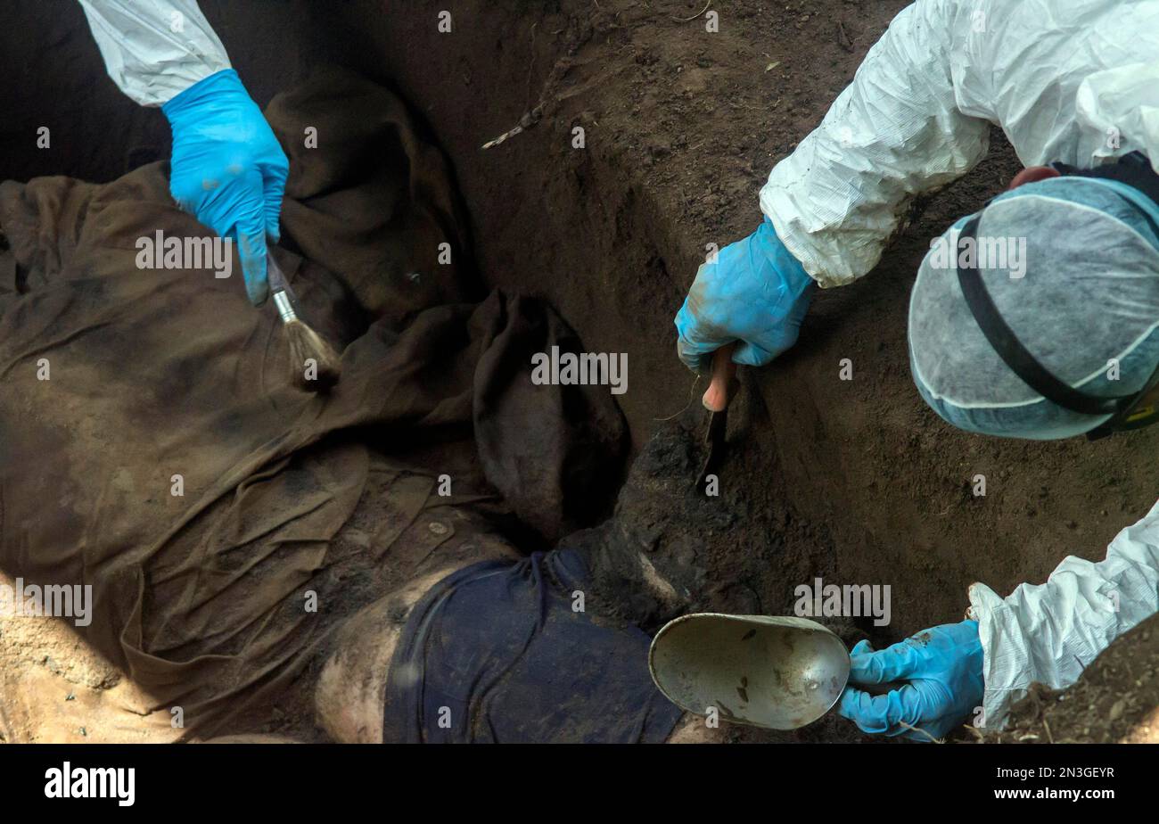 In this Oct. 3, 2014 photo, criminologist Israel Ticas, right, helps to ...
