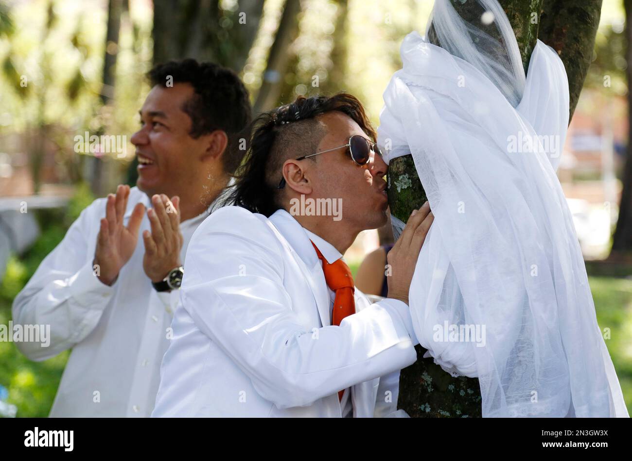 Peruvian environmental activist Richard Torres kisses a tree after a ...