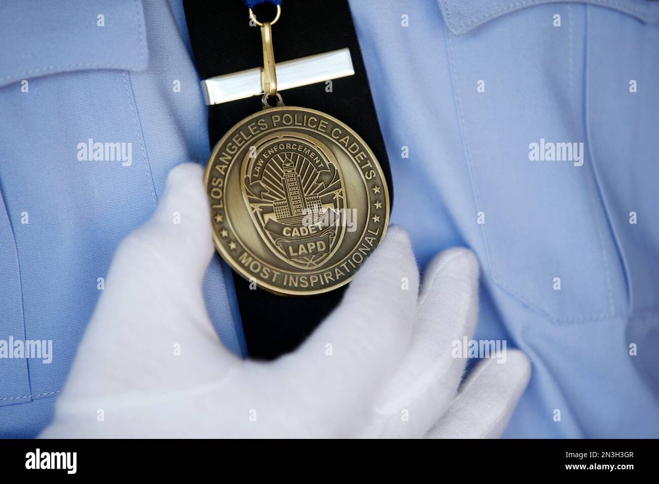 An LAPD cadet graduate holds his most inspiration medal during the LAPD ...