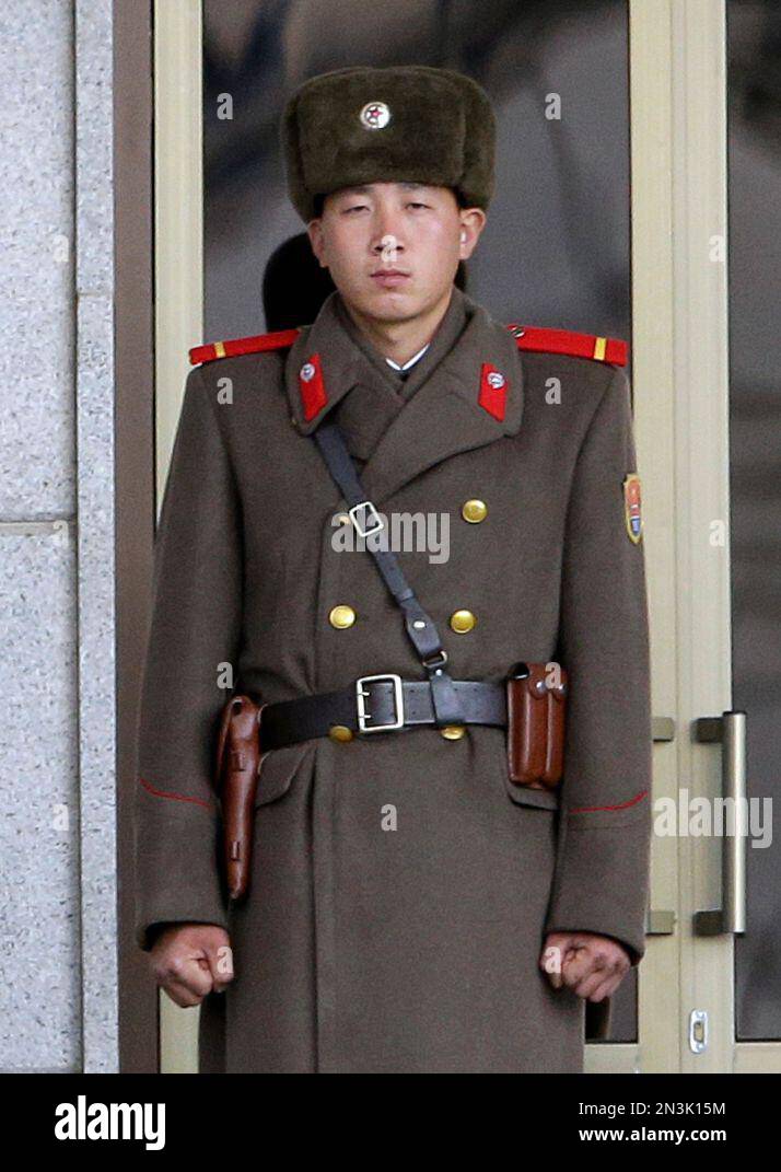 A North Korean soldier looks at the south side at the border village of ...