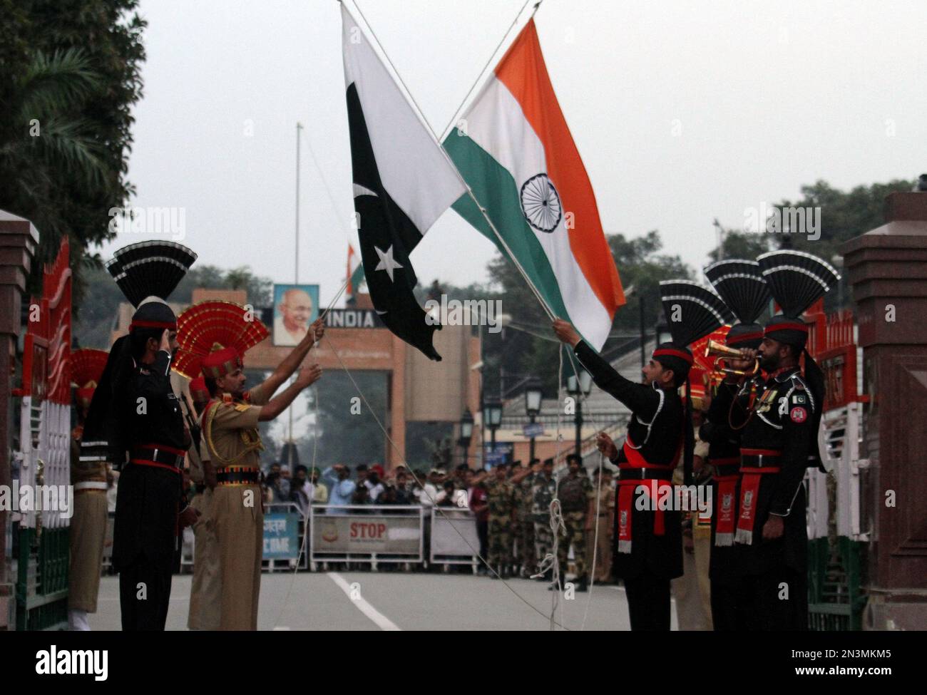 Pakistani border guards perform high kicks during a flag lowering ...