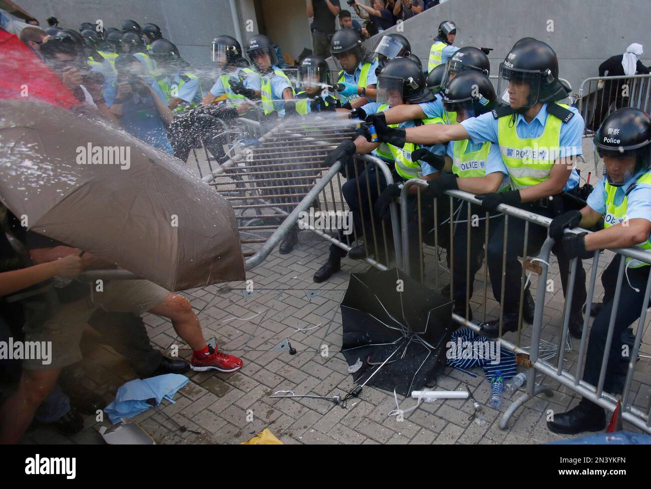 Riot police fire pepper spray into the crowds as thousands of ...