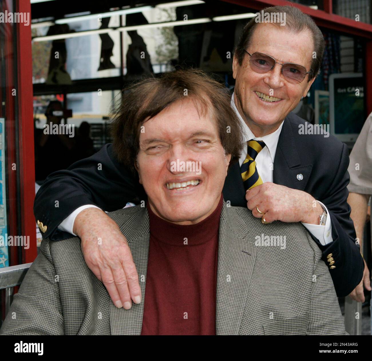 FILE - In this Oct. 11, 2007 file photo, actor Roger Moore, right, who ...