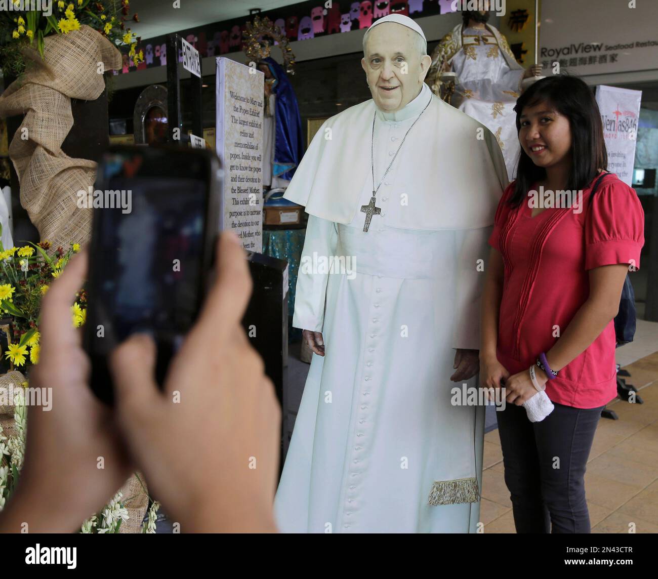Filipinos have their photos taken with a cutout of Pope Francis at SM ...