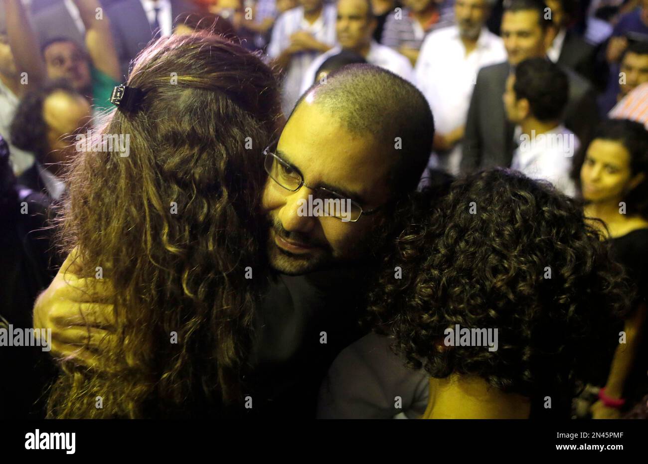 Egyptian prominent blogger Alaa Abdel-Fattah, center, hugs relatives as ...