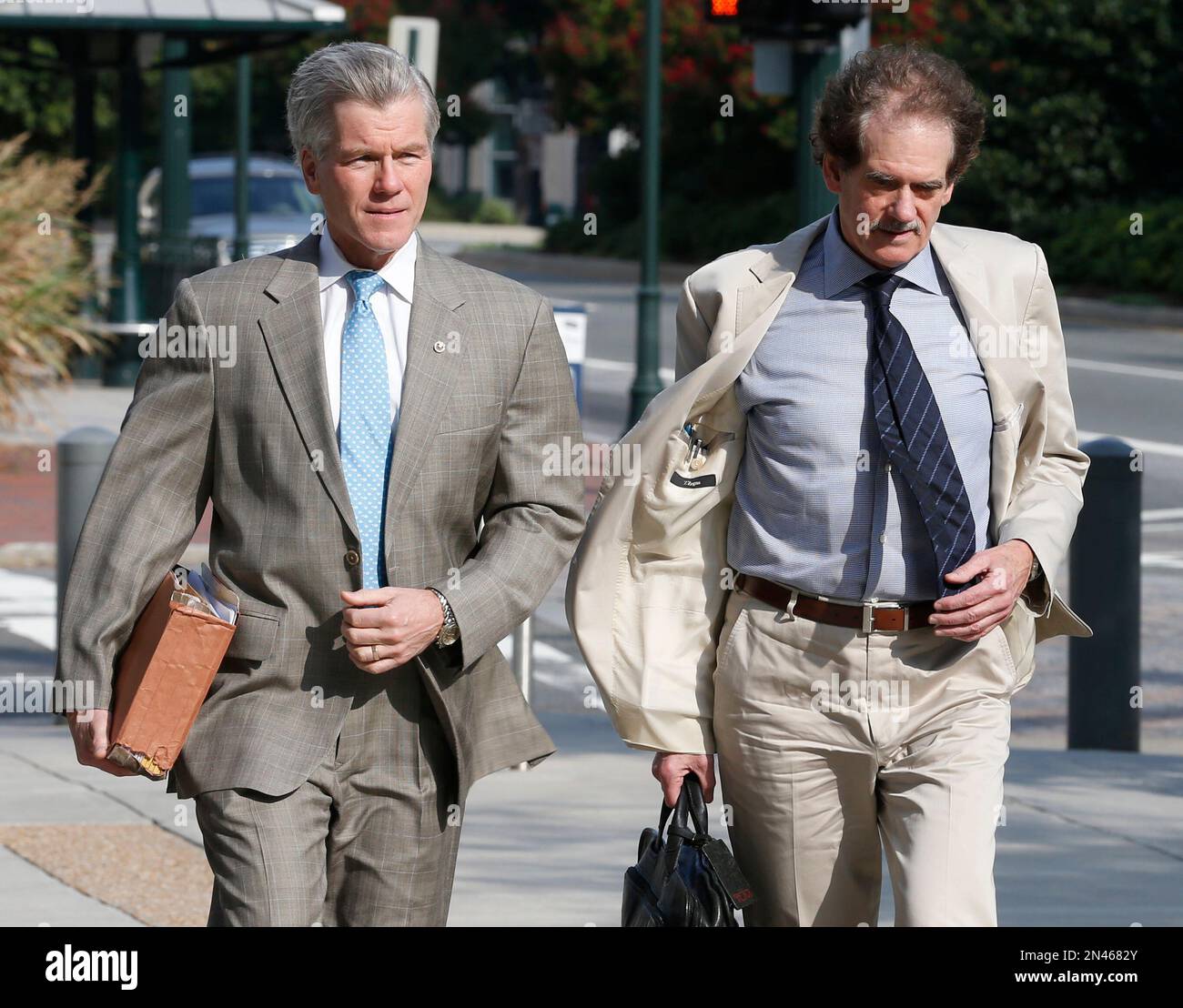 Former Virginia Gov. Bob McDonnell, left, arrives at federal court with ...