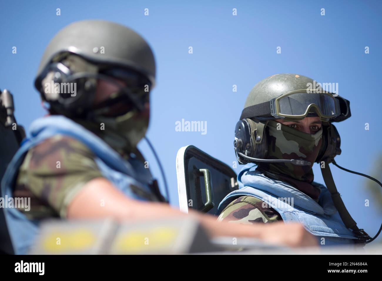 Two UN peacekeepers sit on top of an armored vehicles from the U.N ...