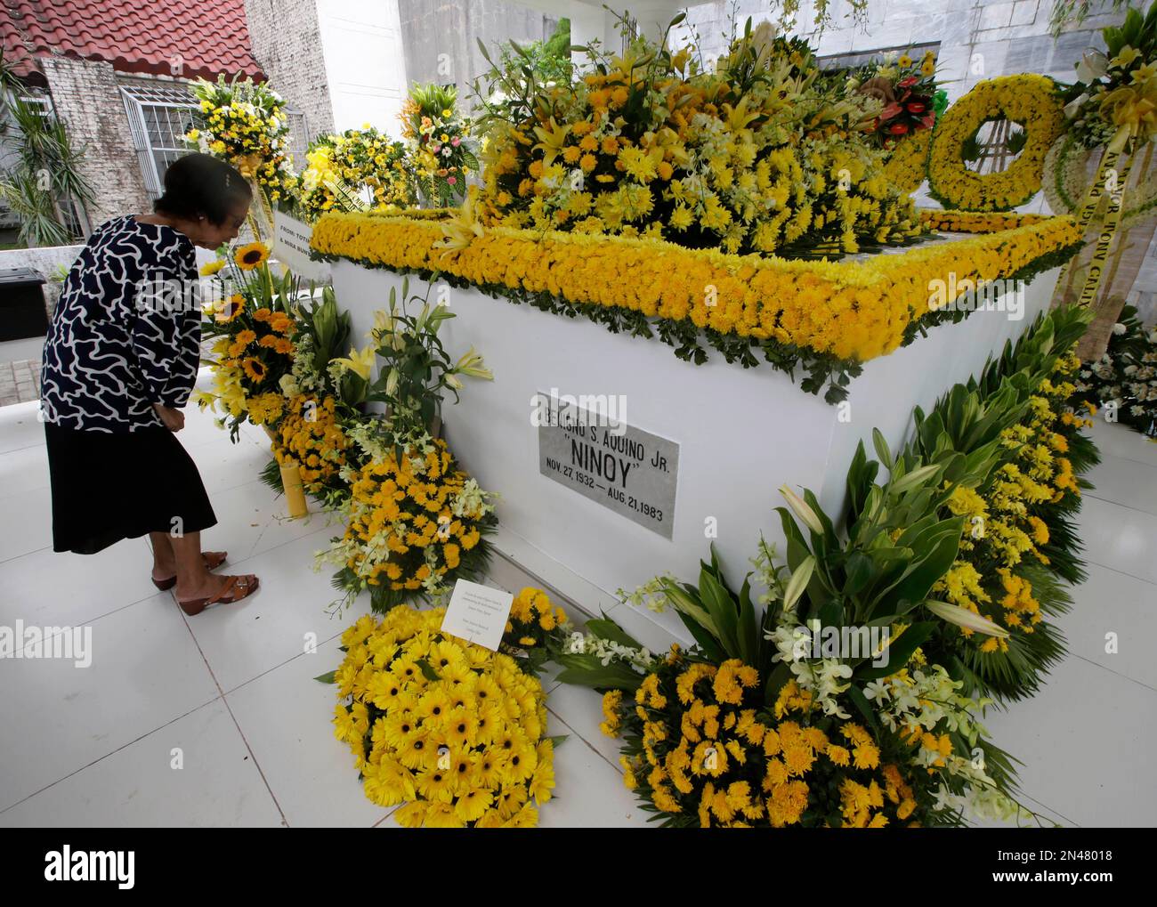 A supporter reads the epitaph at the tombs of assassinated opposition ...