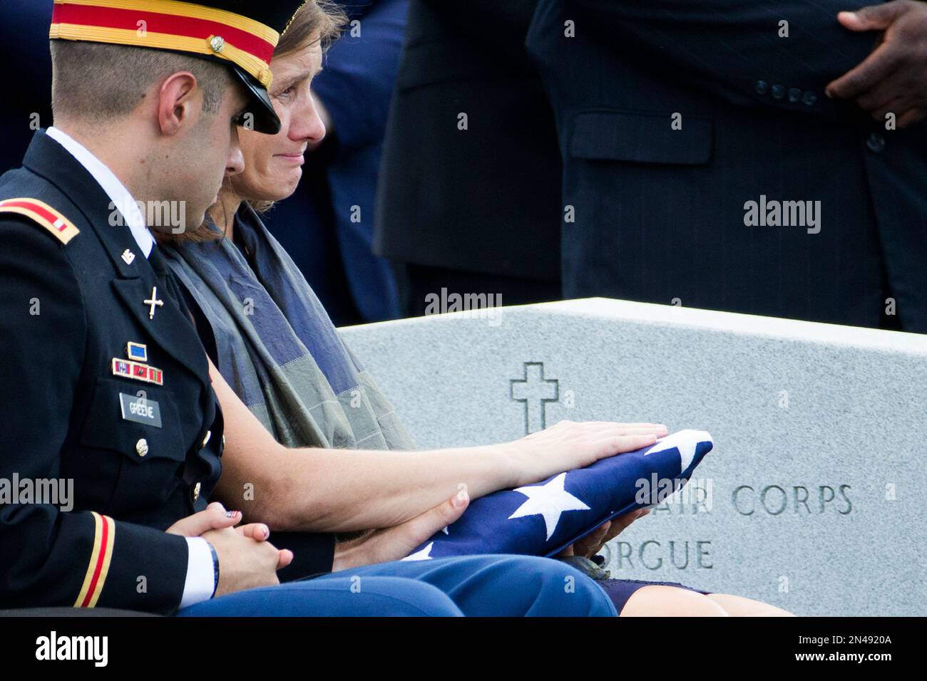 Retired Col. Susan Myers, right, clutches a flag presented to her ...