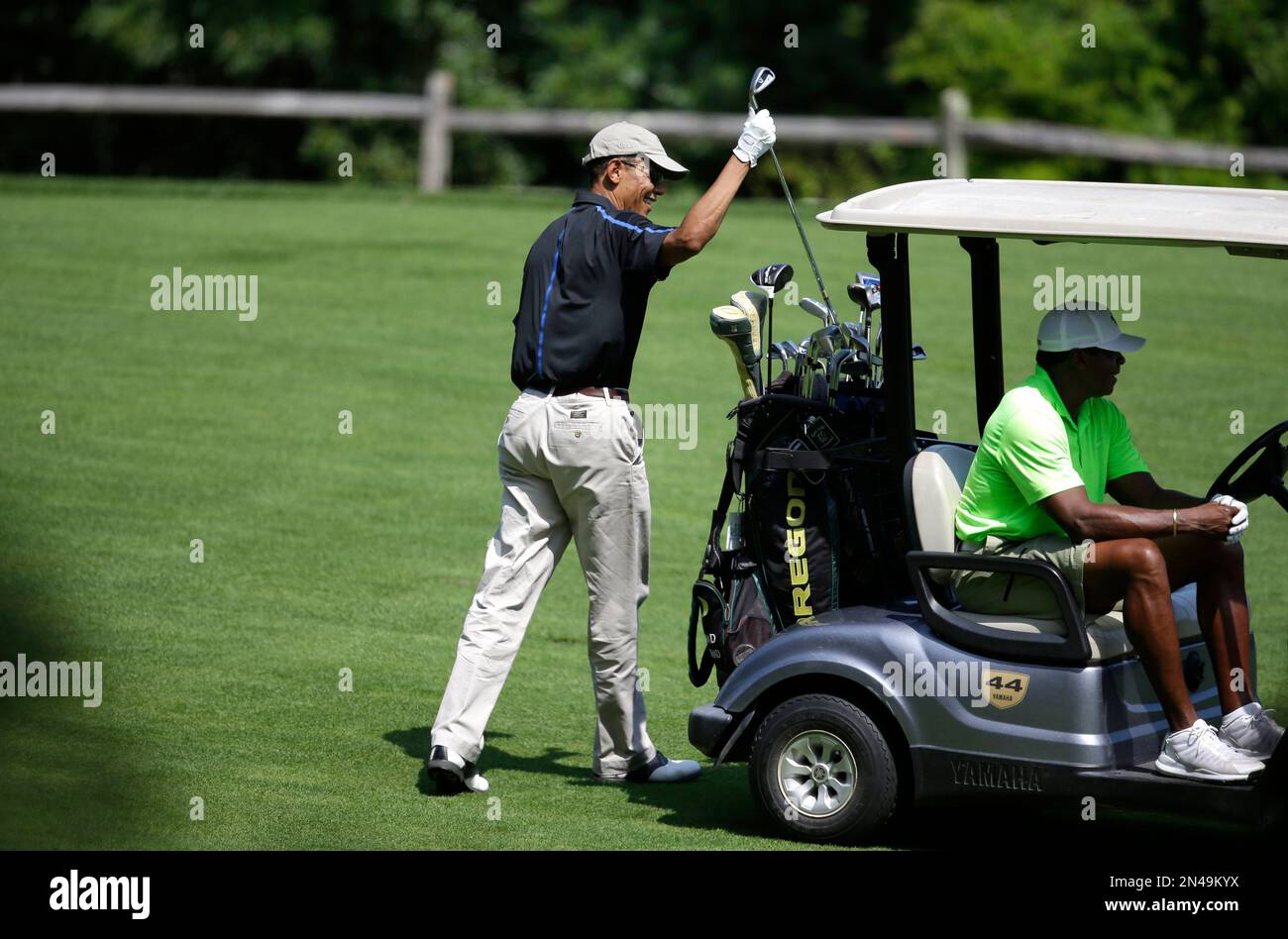 President Barack Obama selects a club while golfing at Farm Neck Golf ...