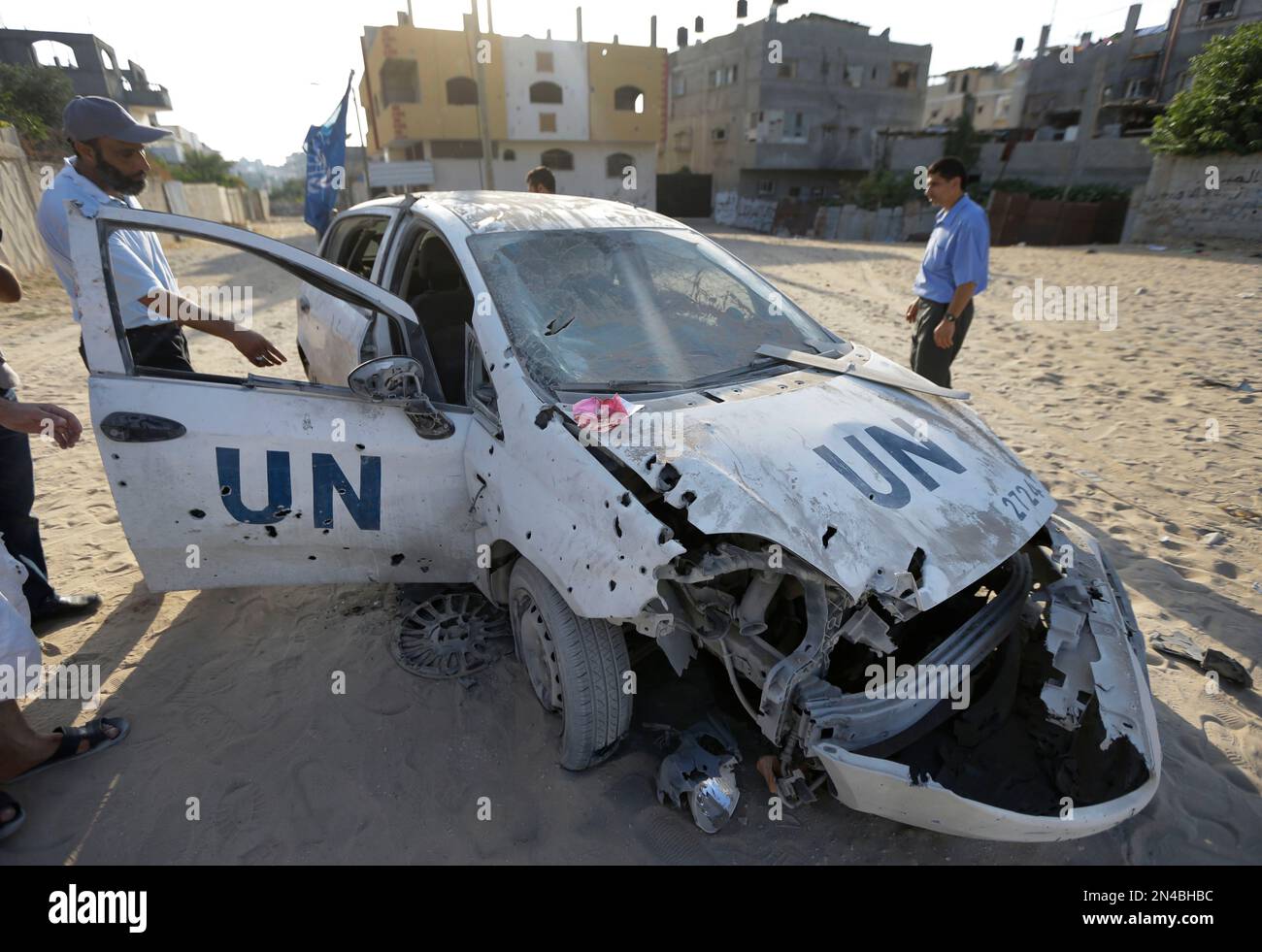 Palestinians gather around a United Nations aid agency car that was ...