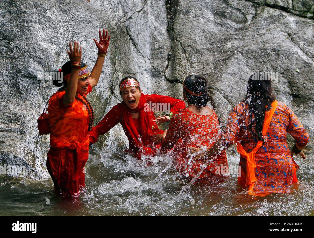 Nepalese Hindu devotees play before collecting water from the Bagmati ...