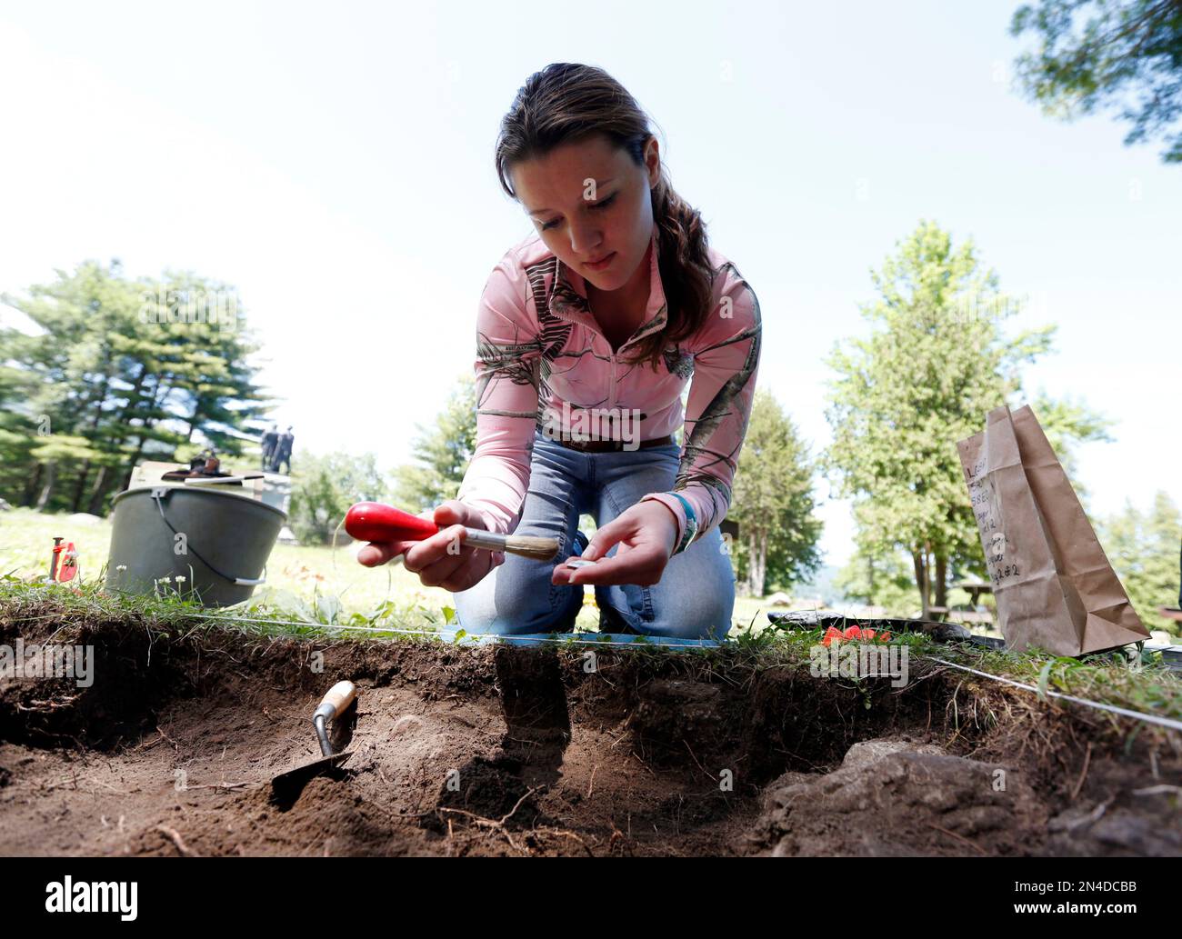 Volunteer Heather Engwer of Lake George examines an artifact during an ...