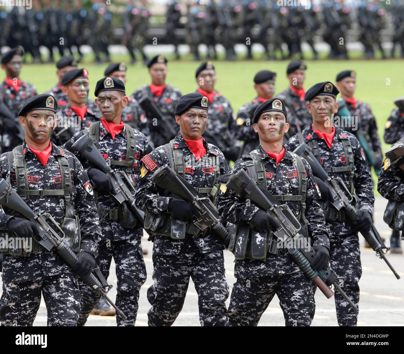 Philippine troops march past the grandstand to welcome the new ...