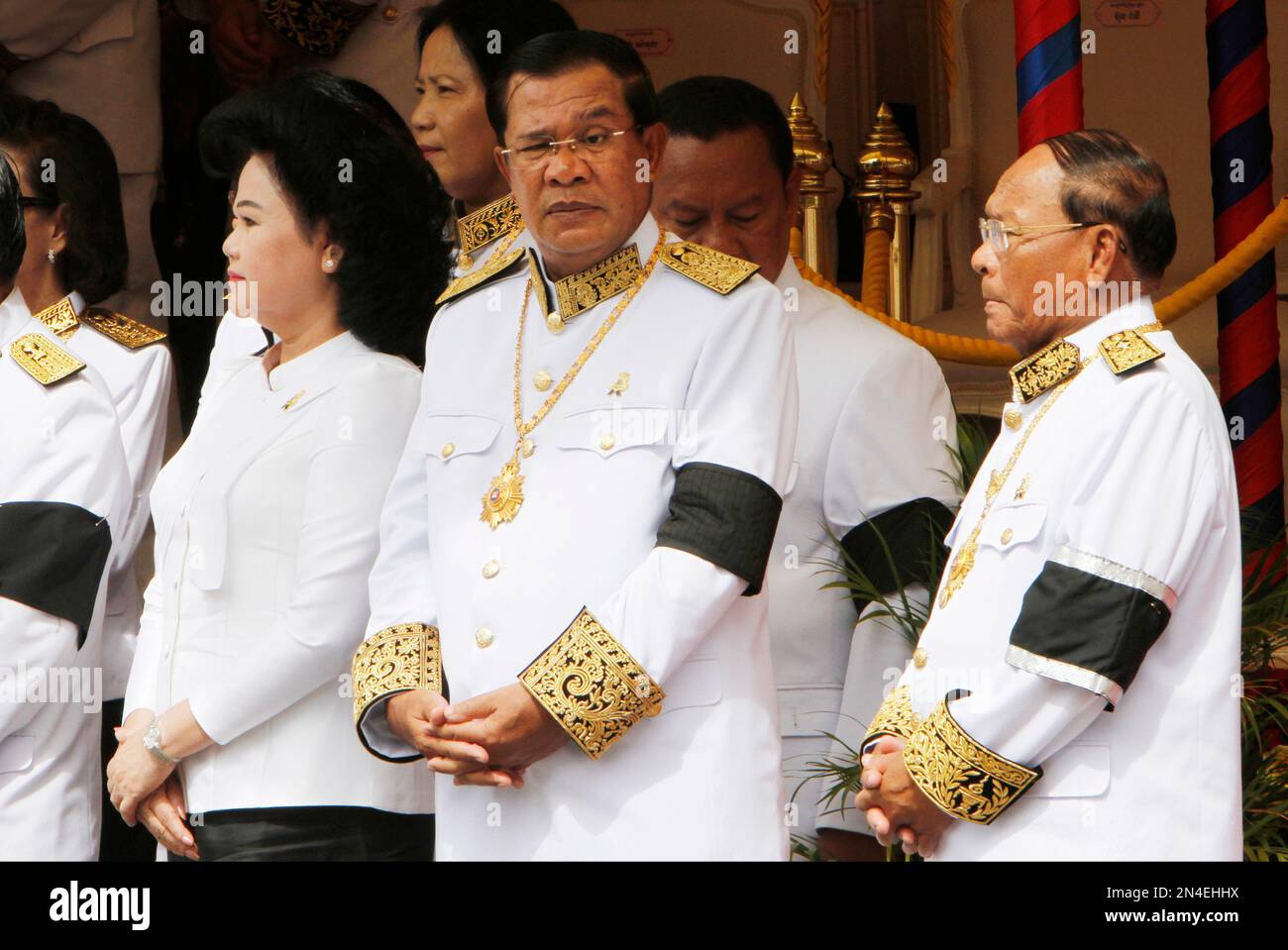 Cambodian Prime Minister Hun Sen, center, stands together with ...