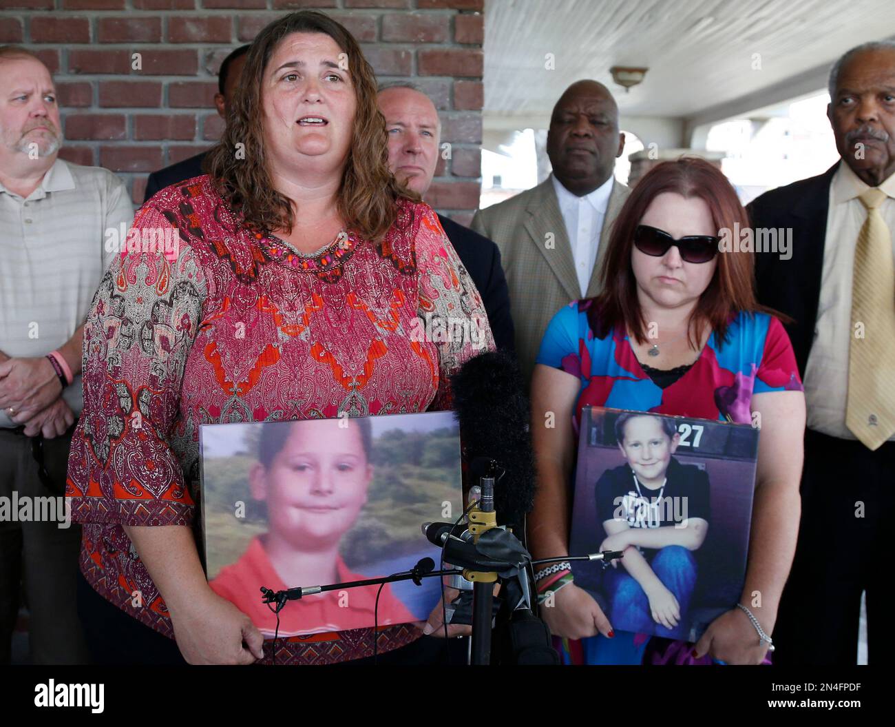 Danni Legg, left, holds a photo of her son, Christopher Legg, 9, who ...