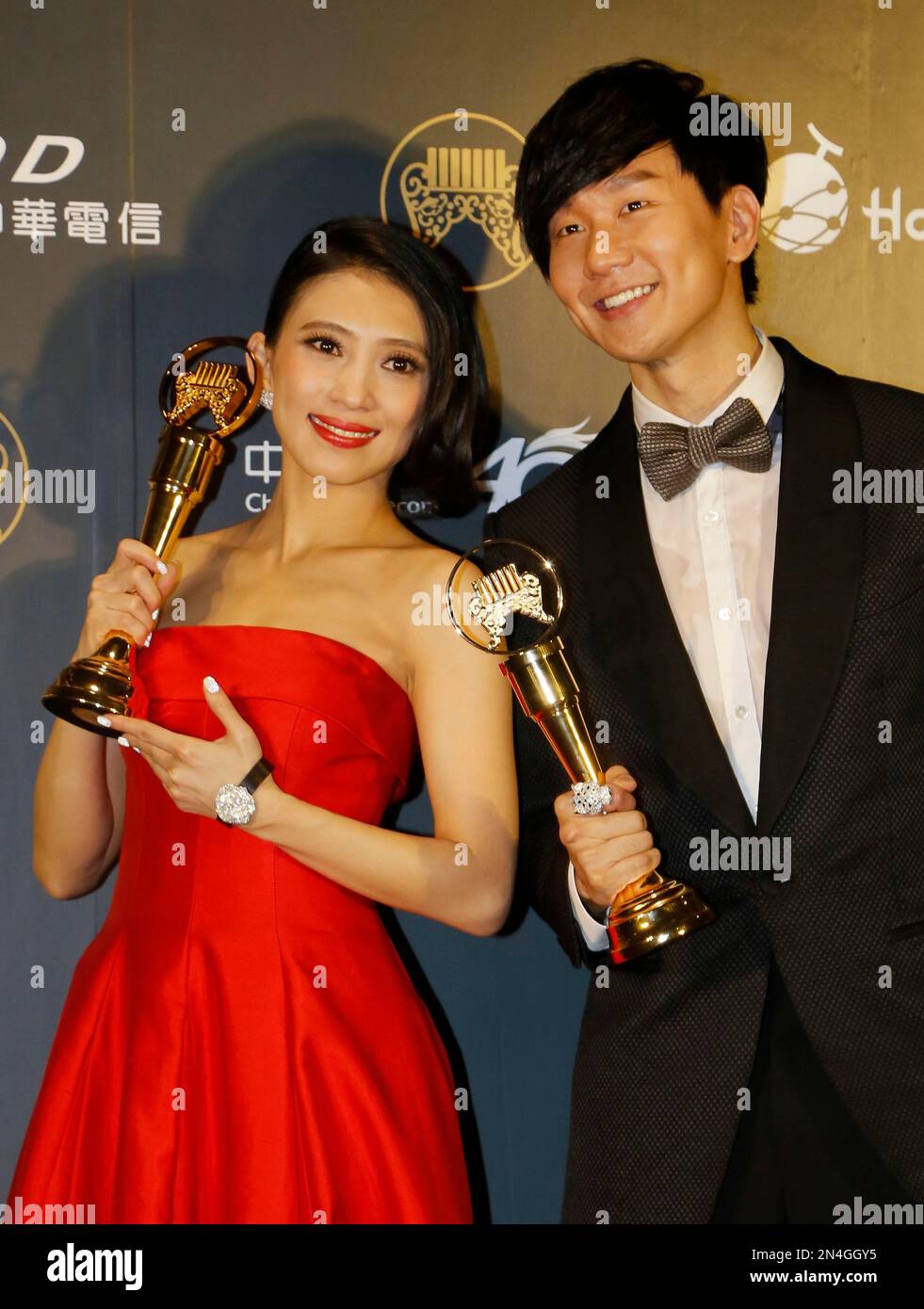 Malaysian singer Penny Tai, left, and Singapore singer JJ Lin hold ...