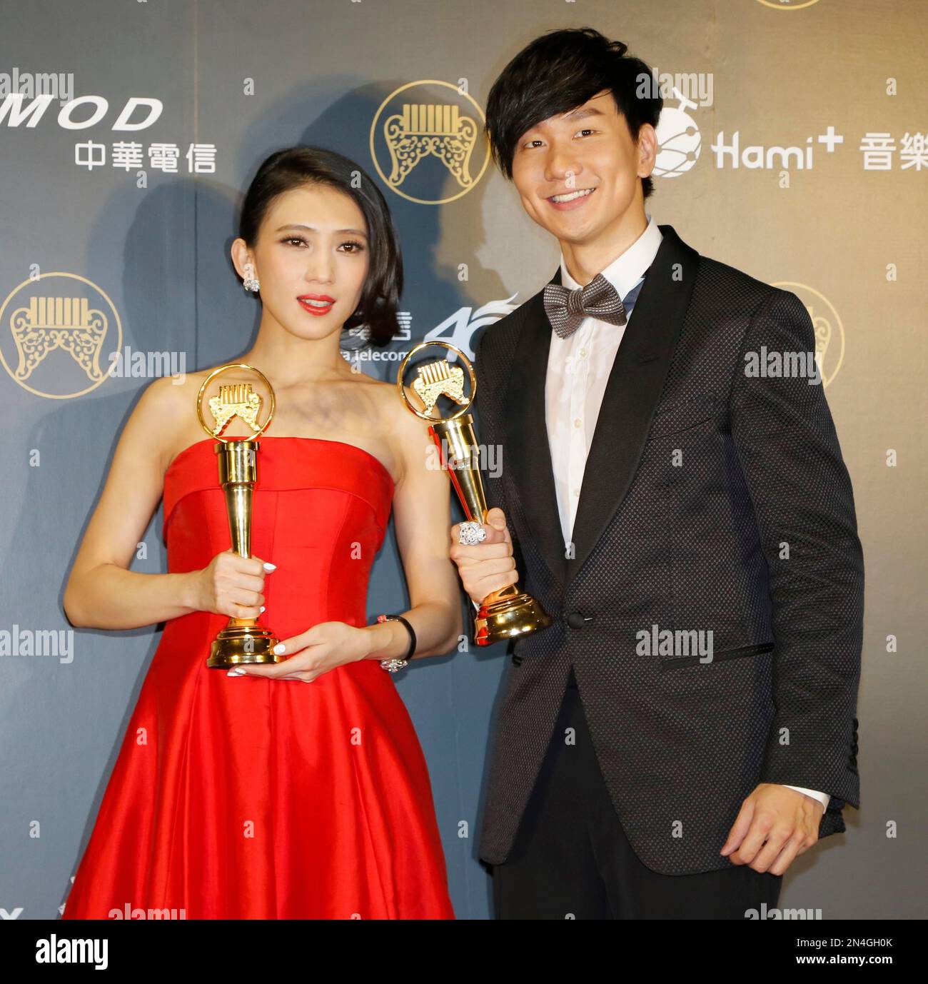Malaysian singer Penny Tai, left, and Singapore singer JJ Lin hold ...