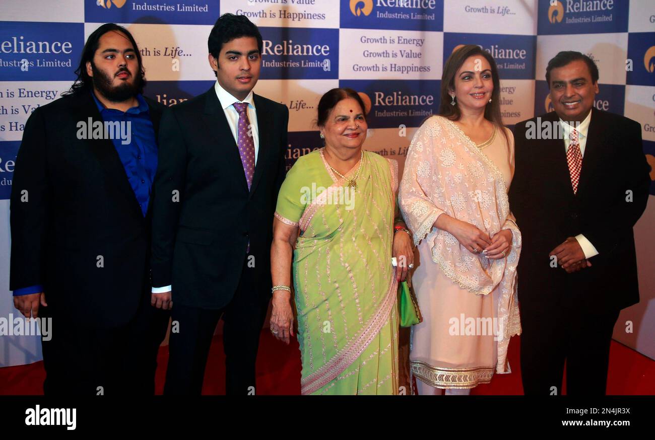 India's largest private sector company, Reliance Industries chairman Mukesh Ambani, right, poses ...